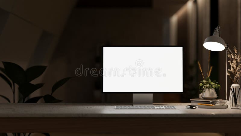 A White-screen Computer Mockup and a Dim Light from a Lamp on a Table ...