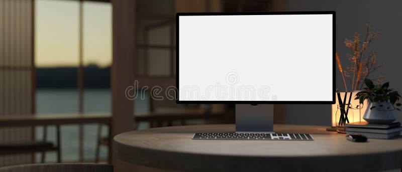 A White-screen PC Computer and Accessories on a Table in a Modern Dark ...