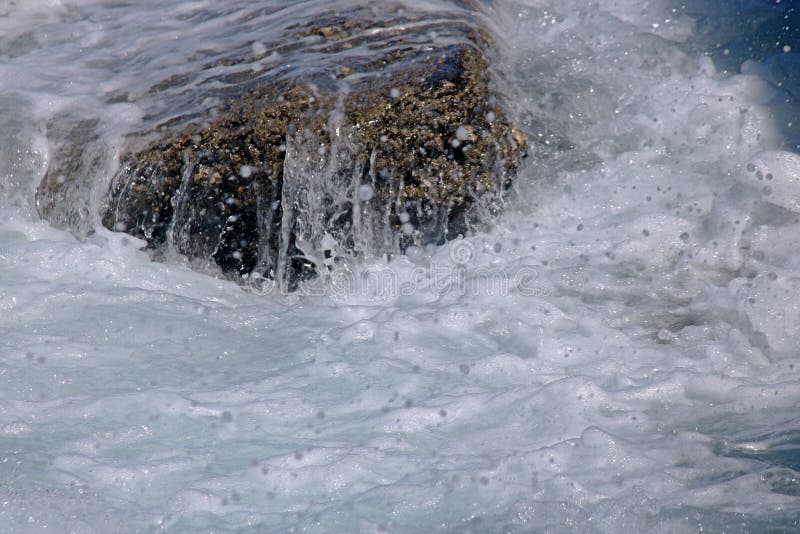 SEA WATER RUNNING OFF ROCK stock photo. Image of seawater - 100425202