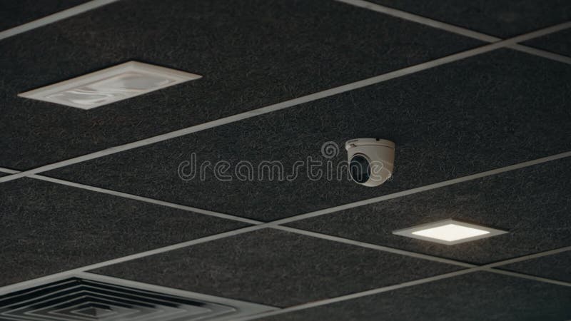 Security Camera Mounted on a Textured Ceiling with Integrated Lighting ...