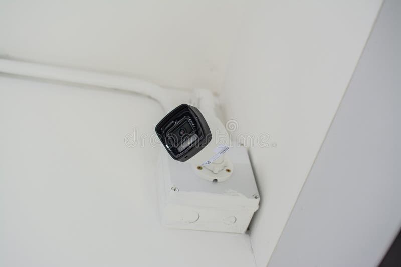White Security Camera Install on a White Wall Stock Image - Image of ...