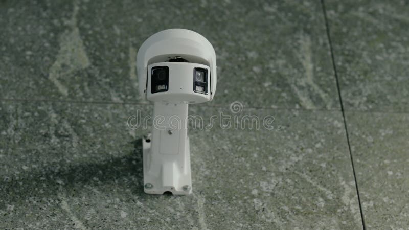 White Security Camera Mounted on a Granite Tile Wall Stock Video ...