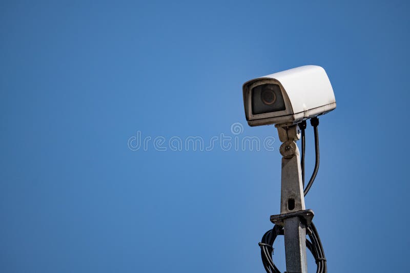 White Security Camera Mounted on Pole Against Blue Sky Stock Image ...
