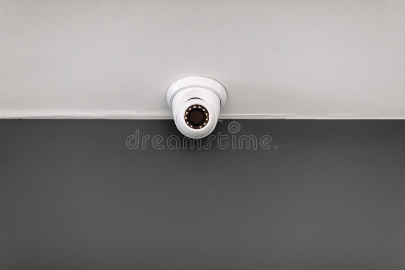 White Security CCTV Camera or Surveillance Operating on Ceiling Inside ...