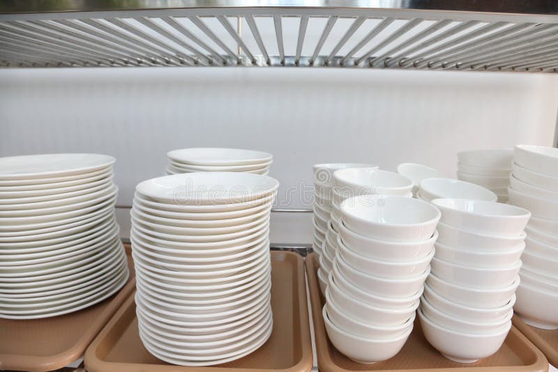 White Set of Ceramic Including Plate, Dish, Cup Stacking Up the Rack ...