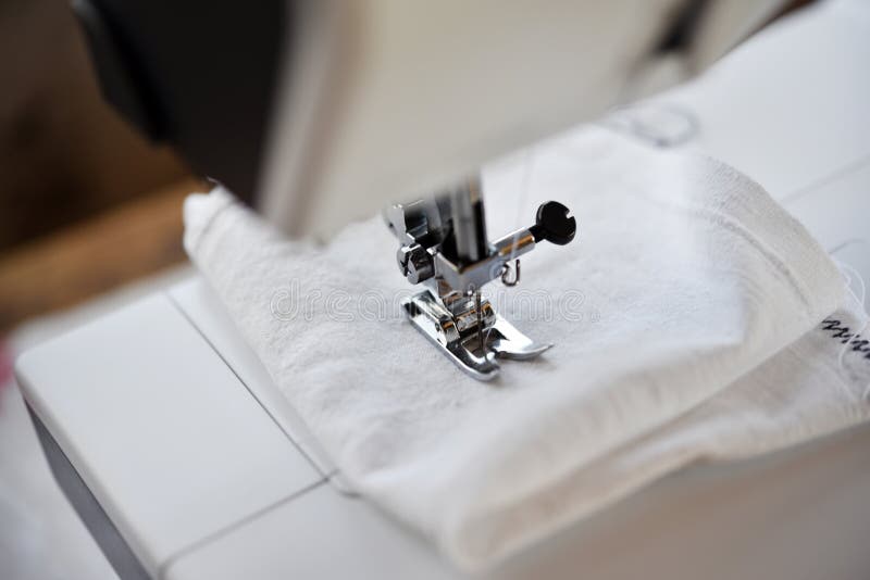 A White Sewing Machine in the Room. Processing of Clothes with a Sewing ...