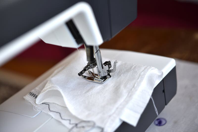 A White Sewing Machine in the Room. Processing of Clothes with a Sewing ...