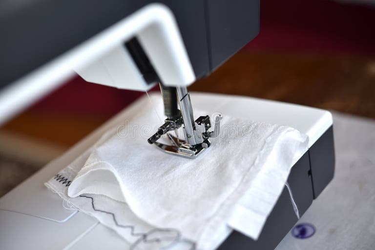 A White Sewing Machine in the Room. Processing of Clothes with a Sewing ...
