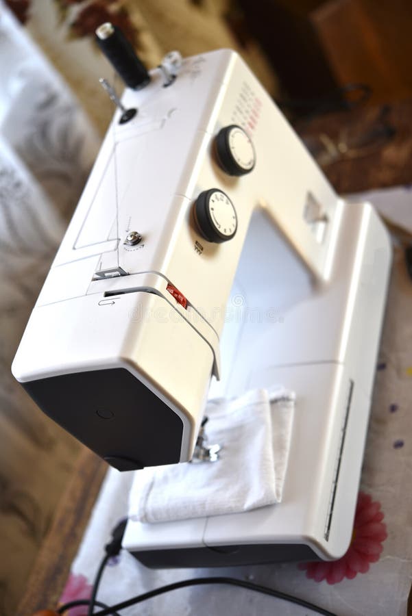 A White Sewing Machine in the Room. Processing of Clothes with a Sewing ...