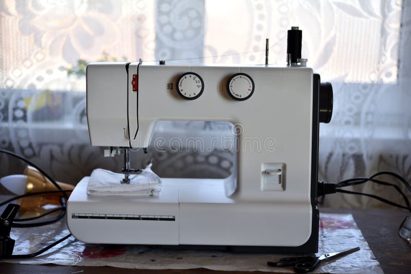 A White Sewing Machine in the Room. Processing of Clothes with a Sewing ...