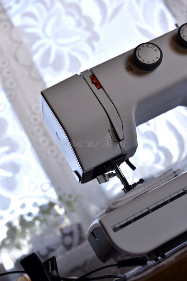 A White Sewing Machine in the Room. Processing of Clothes with a Sewing ...