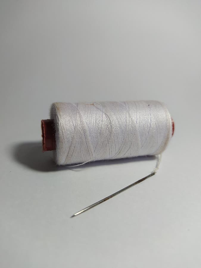 White Sewing Thread Spool and Needle. White Sewing Thread Stock Photo ...