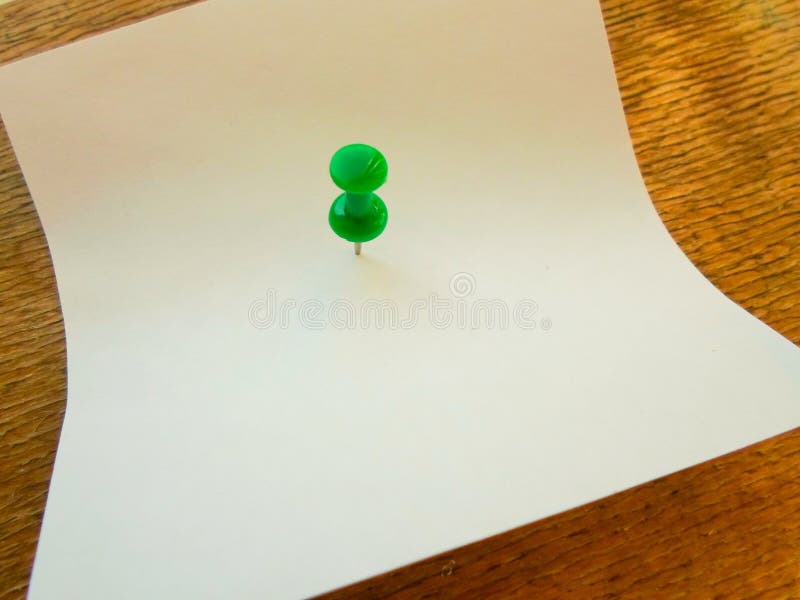 White Sheet of Paper on a Wooden Table with a Green Pin Stock Photo ...