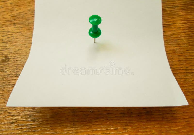 White Sheet of Paper on a Wooden Table with a Green Pin Stock Image ...