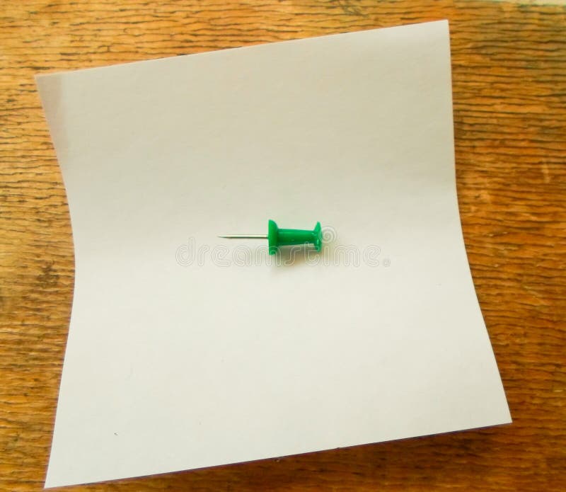 White Sheet of Paper on a Wooden Table with a Green Pin Stock Image ...