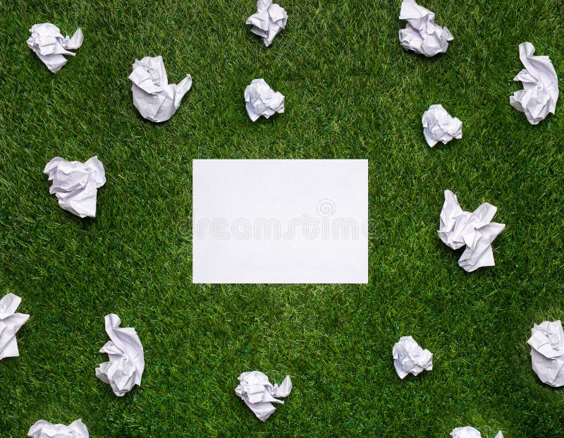 White Sheets of Paper with Cramled Sheets Lying on the Grass Stock ...