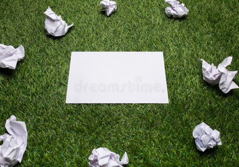 White Sheets of Paper with Crampled Sheets Lying on the Grass Stock ...