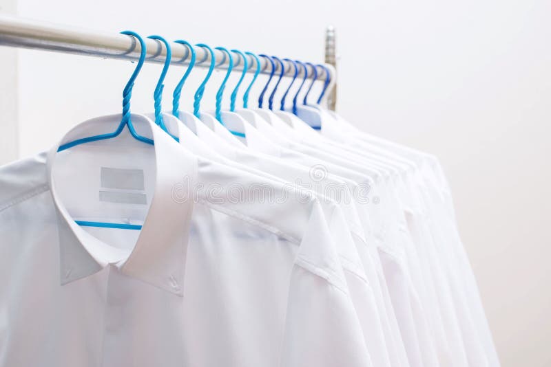 White Shirts Hanging on Rack in a Row Stock Image - Image of store ...