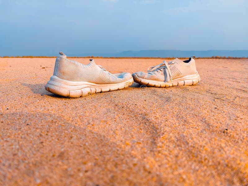A white shoes in Sand land stock photo. Image of orange - 218779136