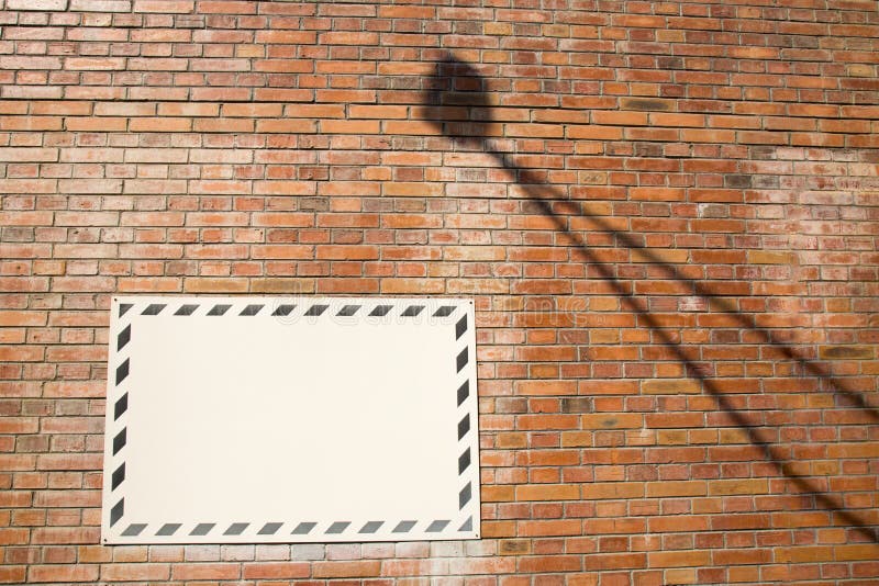 White Sign on Brick Wall with Lamp Shadow Stock Photo - Image of ...