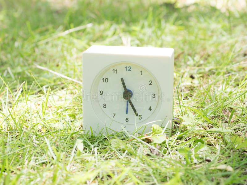 White Simple Clock on Lawn Yard, 11:25 Eleven Twenty Five Stock Photo ...
