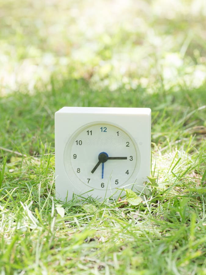 White Simple Clock on Lawn Yard, 7:15 Seven Fifteen Stock Image - Image ...
