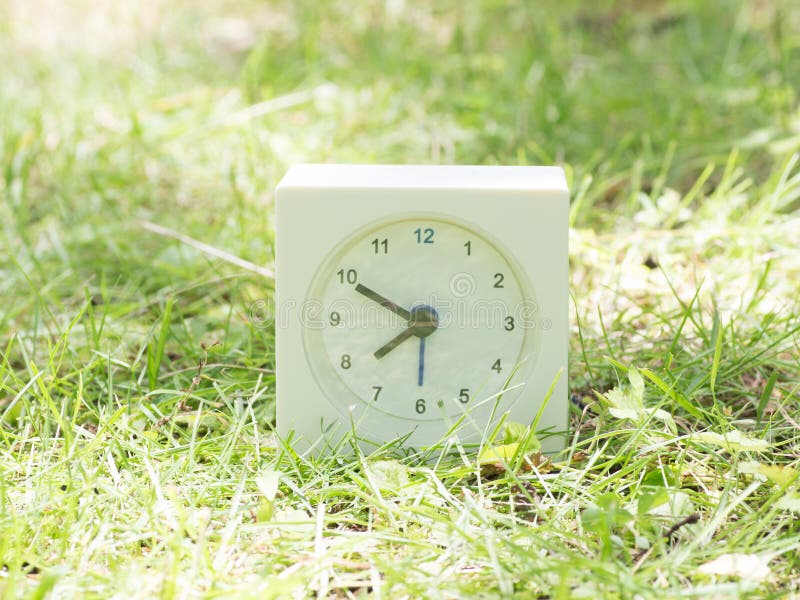 White Simple Clock on Lawn Yard, 7:50 Seven Fifty Stock Image - Image ...