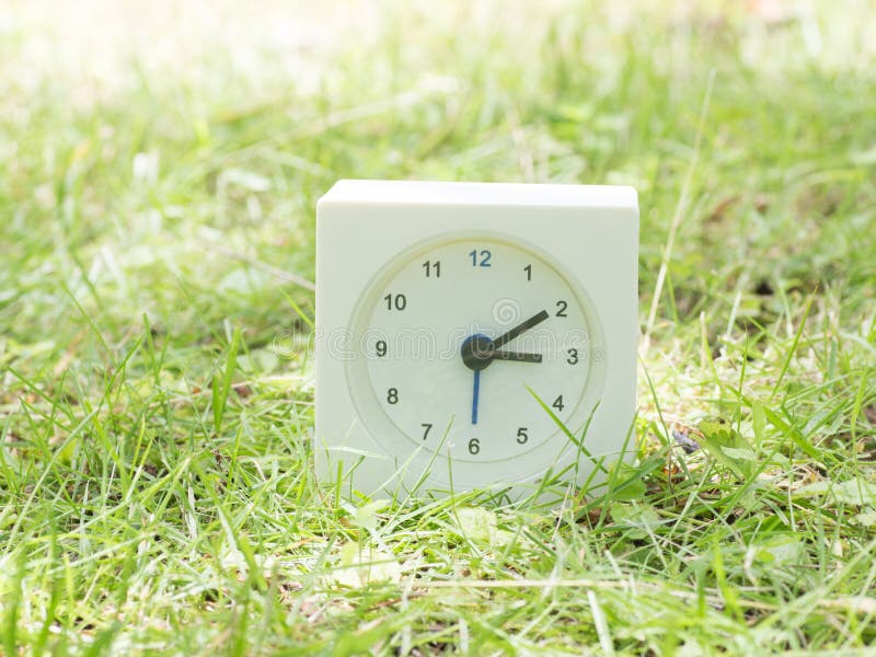 White Simple Clock on Lawn Yard, 3:10 Three Ten Stock Image - Image of ...