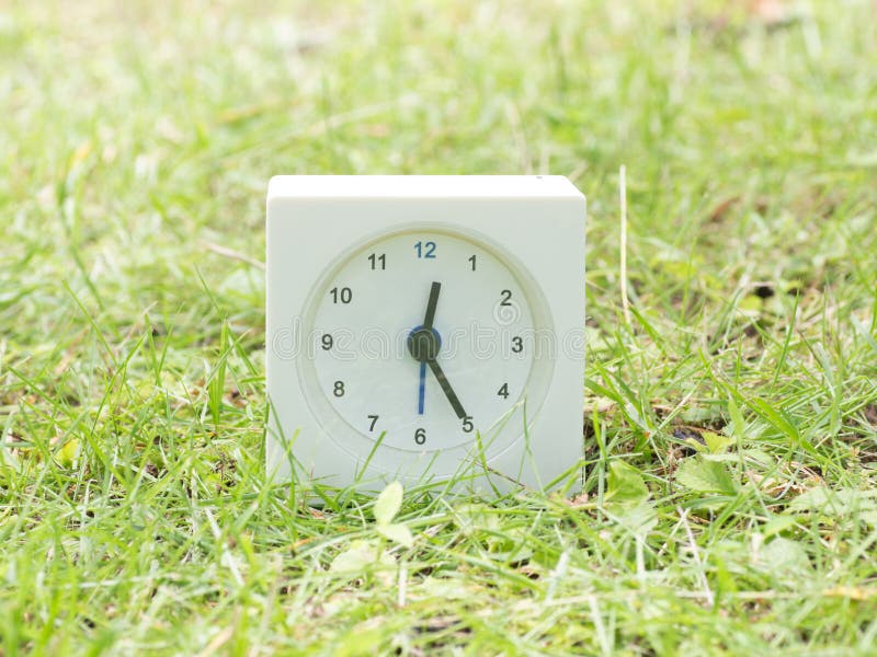 White Simple Clock on Lawn Yard, 12:25 Twelve Twenty Five Stock Image ...