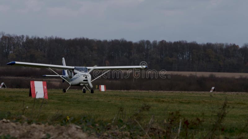 A White Single-engine Light Plane Takes Off from the Runway. Stock ...