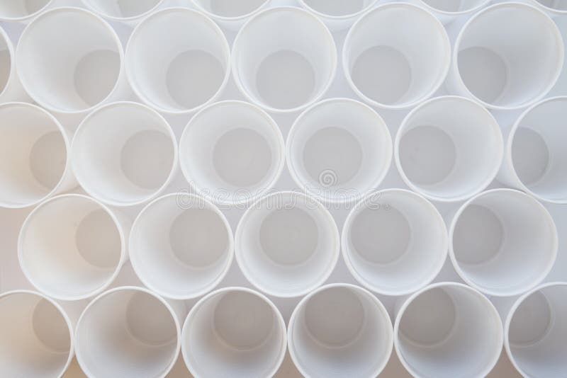 White Single-use Plastic and Other Plastic Items on a Yellow Background ...