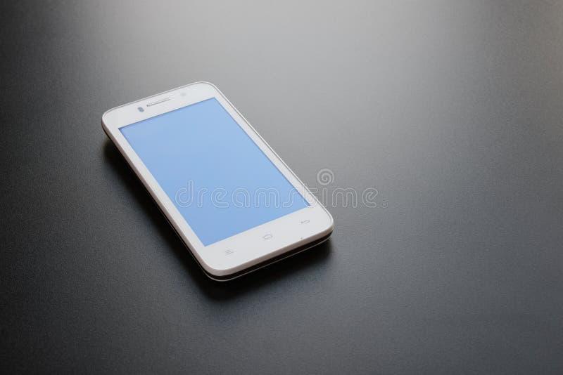 White Smart Phone with Blue Screen on the Black Table Stock Image ...