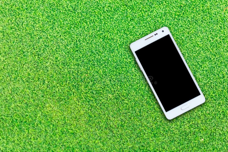 White Smart Phone on Grass Background Stock Image - Image of show ...