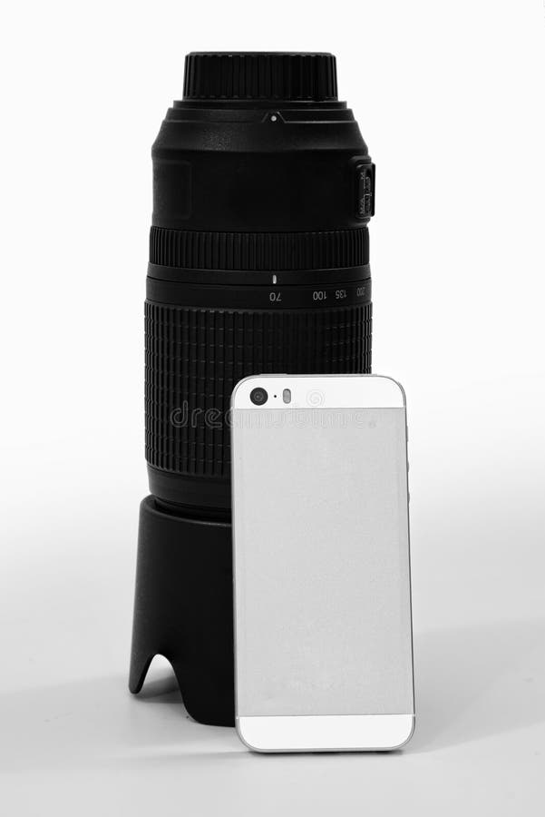 White Smartphone Leaning on Large DSLR Lens Stock Image - Image of ...