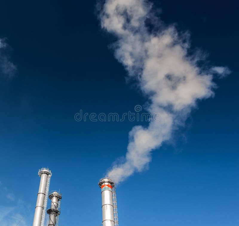 White Smoke from Coal Powered Plant Stacks, Profiled on Bright Blue Sky ...