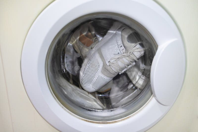 White Sneakers in Laundry Machine. Washing Machine in the Process Stock ...