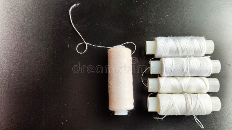 White Spools of Thread on a Black Background. Black Card with Frame ...