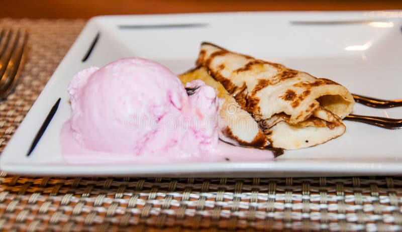 On a White Square Plate Crepe with Chocolate and Raspberry Ice C Stock ...