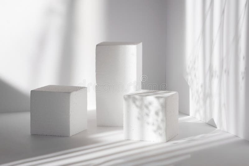 White Square Stands, Different Heights, Against Background of the Walls ...