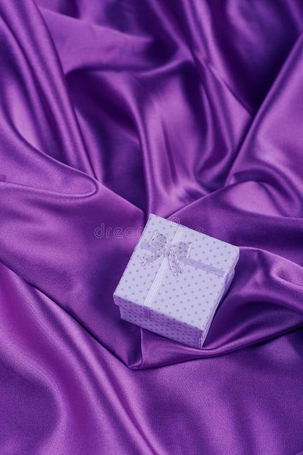 White Squared Gift Box on Purple Satin Fabric Folds Stock Photo - Image ...