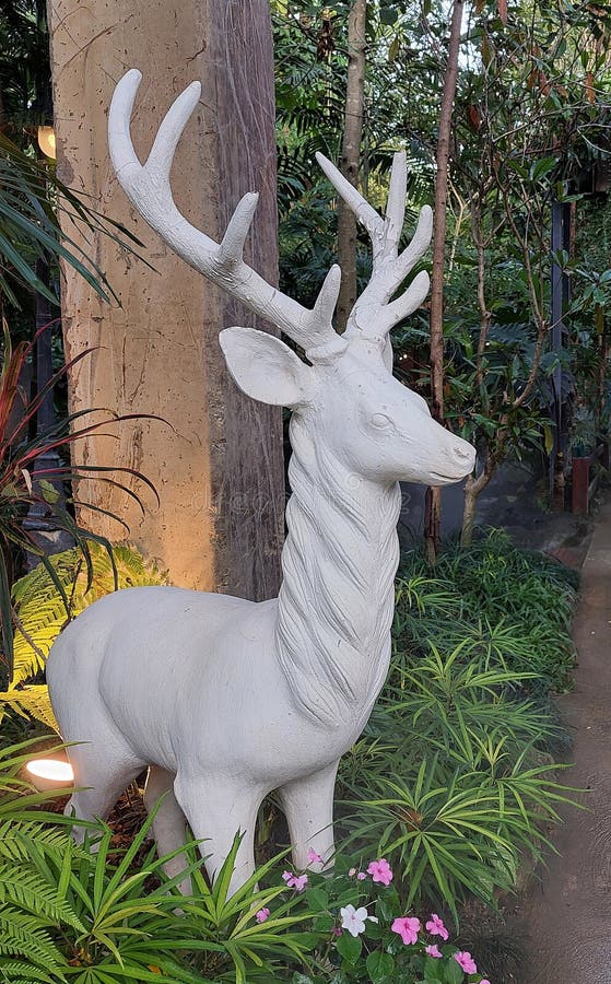 A White Stone Deer Statue in the Tropical Garden Stock Image - Image of ...