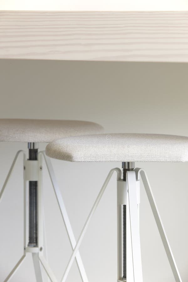 White Stools with Wooden Table and a Wall Stock Image - Image of ...