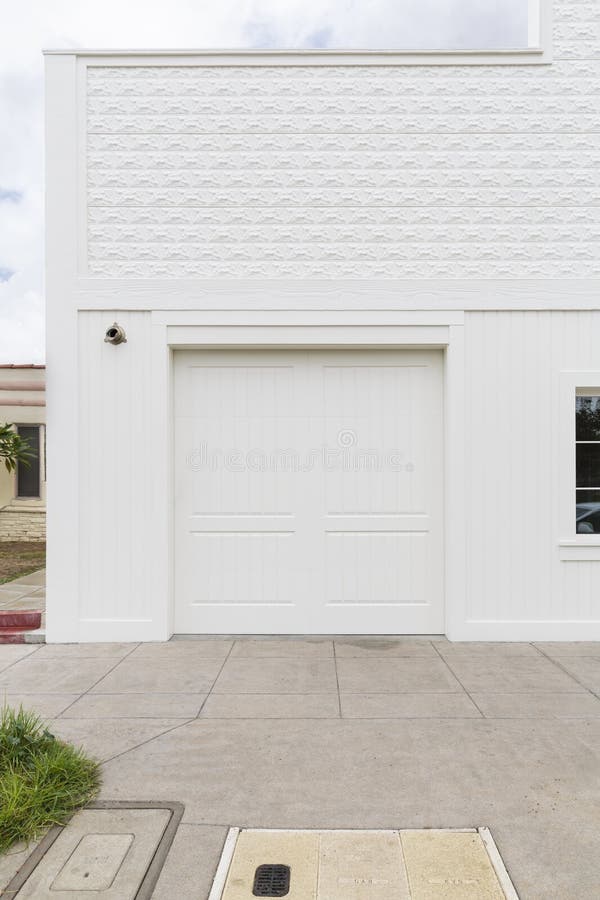 White Storefront Building with Garage Stock Image - Image of economy ...