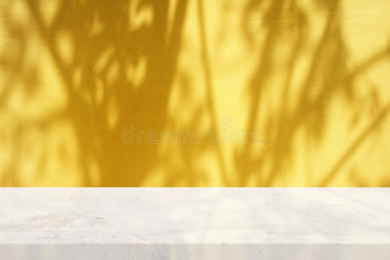 White Stucco Table with Shadow of Tree in the Garden on Yellow Wall ...