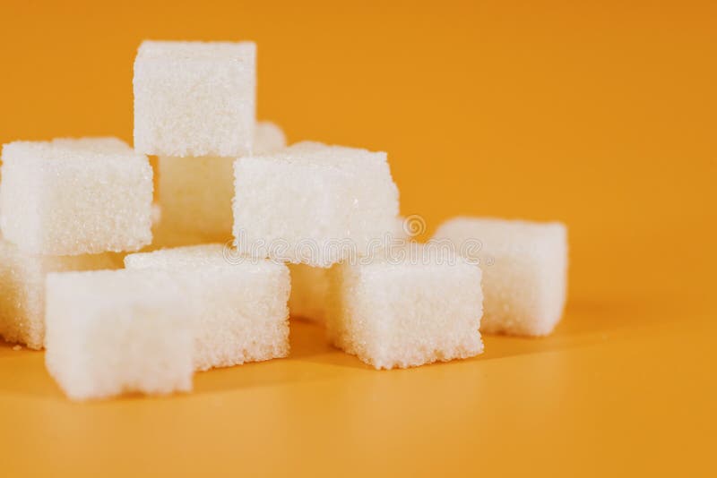 White Sugar Cubes on Yellow Background. Cubes of Sugar Stock Photo ...