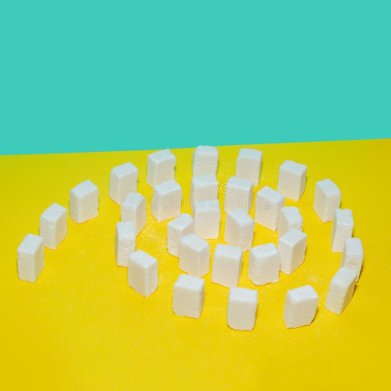 White Sugar Cubes on a Yellow and Blue Background. Creative Concept Top ...
