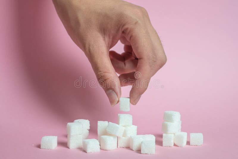White Sugar Loaf on the Pink Floor and the Male Hand Holding the Sugar ...