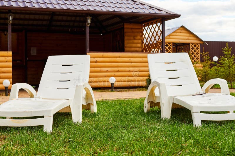 White Sunbed in the Garden with Small House. Conctpt of Summer Rest ...