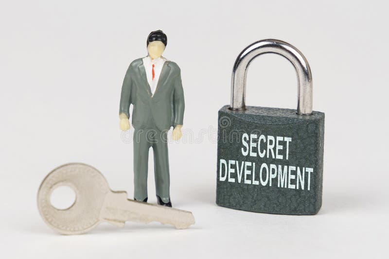 On a White Surface There is a Figurine of a Businessman, a Key and a ...