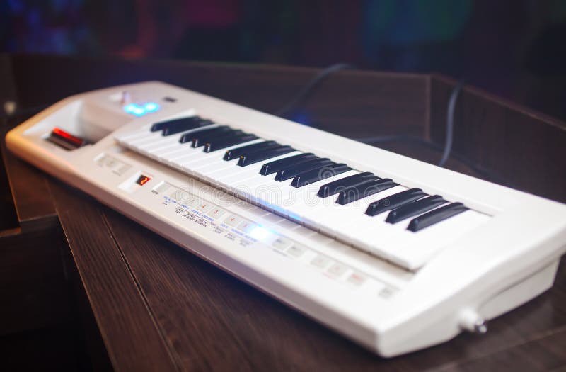 White Synthesizer with Black Buttons on the Table Stock Image - Image ...